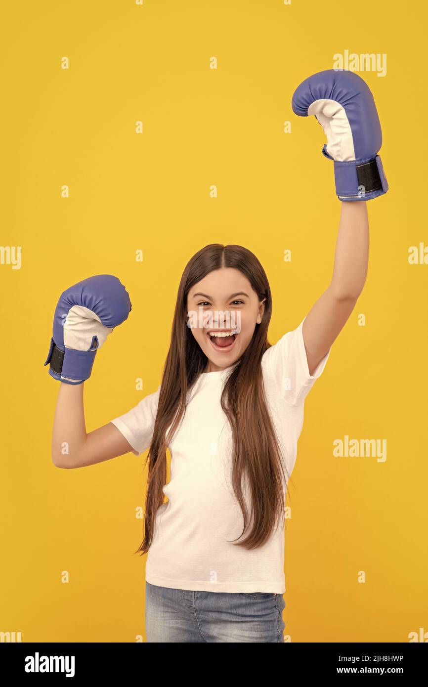 happy shouting child in boxing gloves on yellow background Stock Photo ...