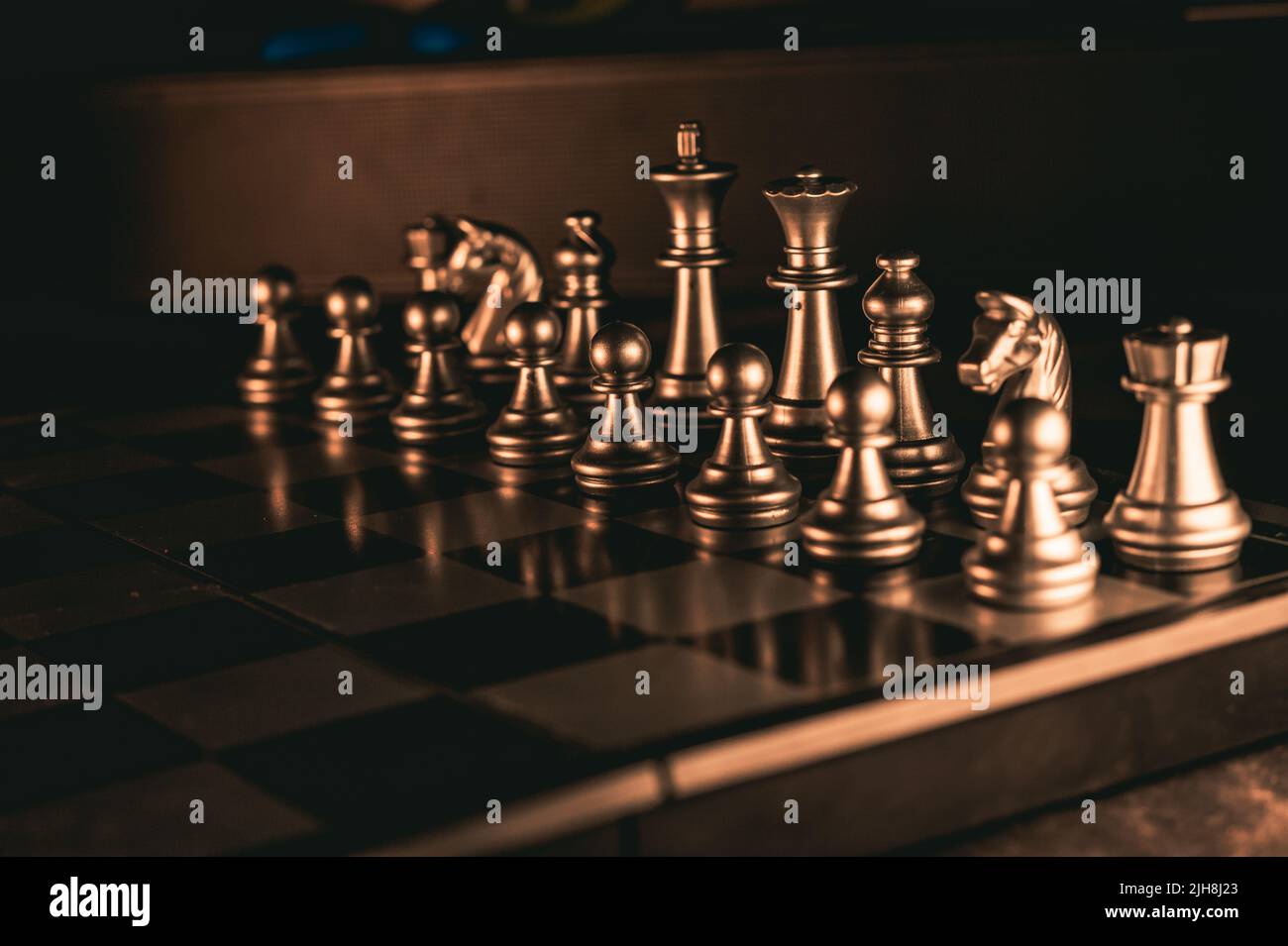 A golden chess pieces placed on the table Stock Photo - Alamy