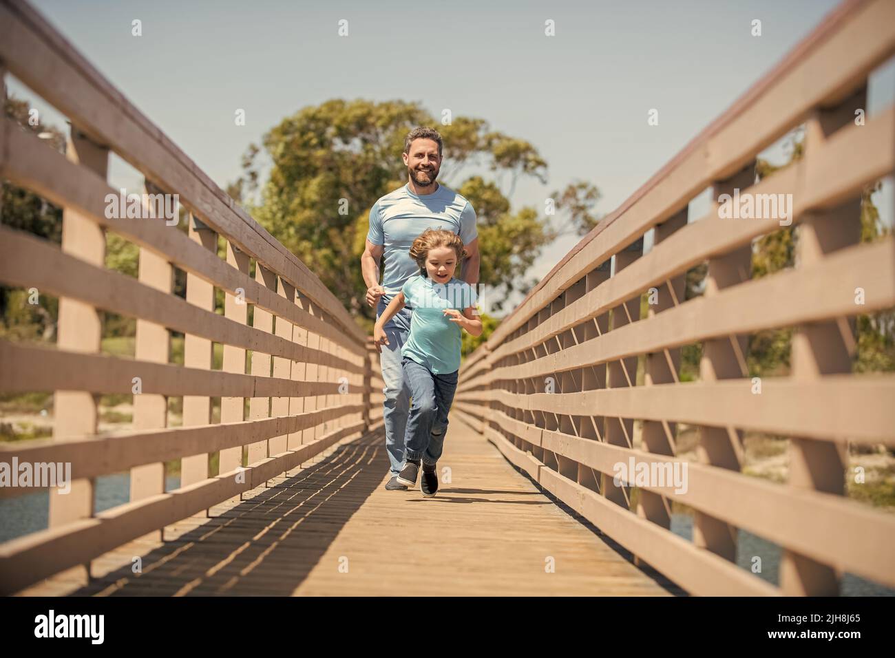 happy father running with his son outside, fun Stock Photo - Alamy