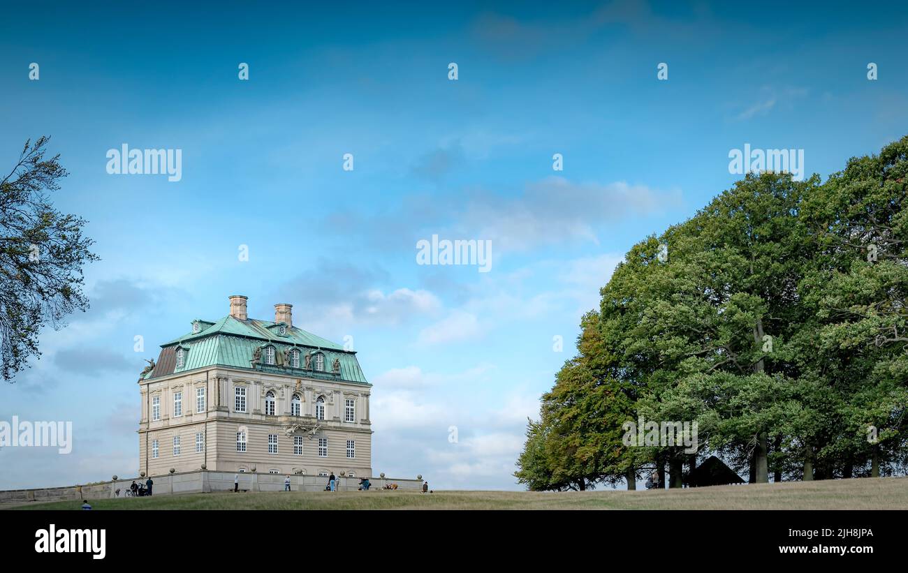A beautiful view of Hermitage Palace at dyrehaven deer park in Denmark ...