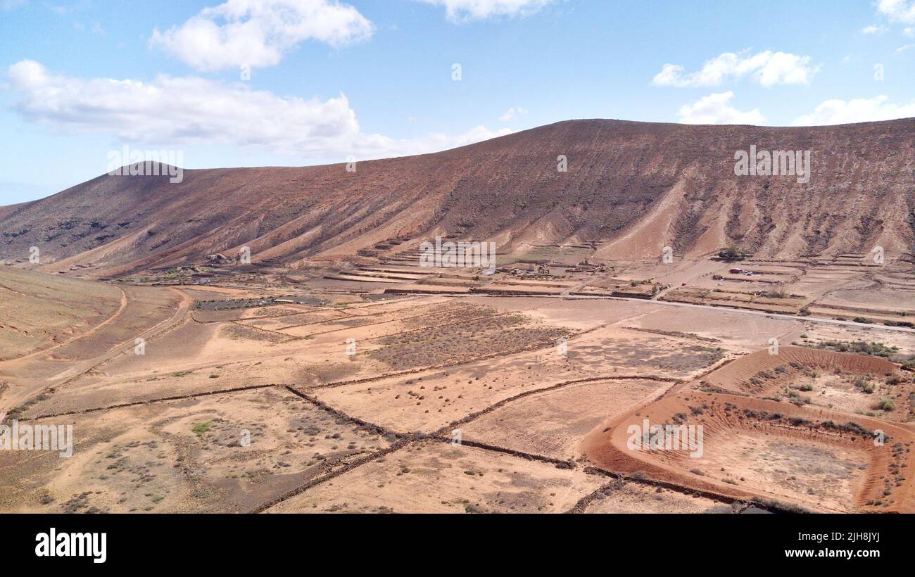 A wide desert field with canyons and mountain Stock Photo - Alamy