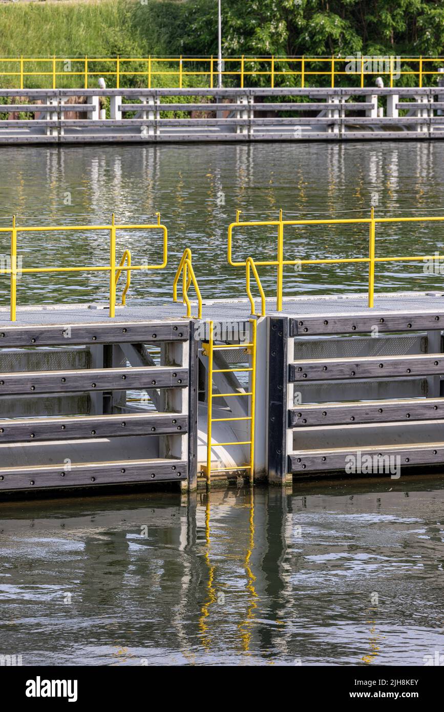 A river dike with yellow steel fence Stock Photo - Alamy