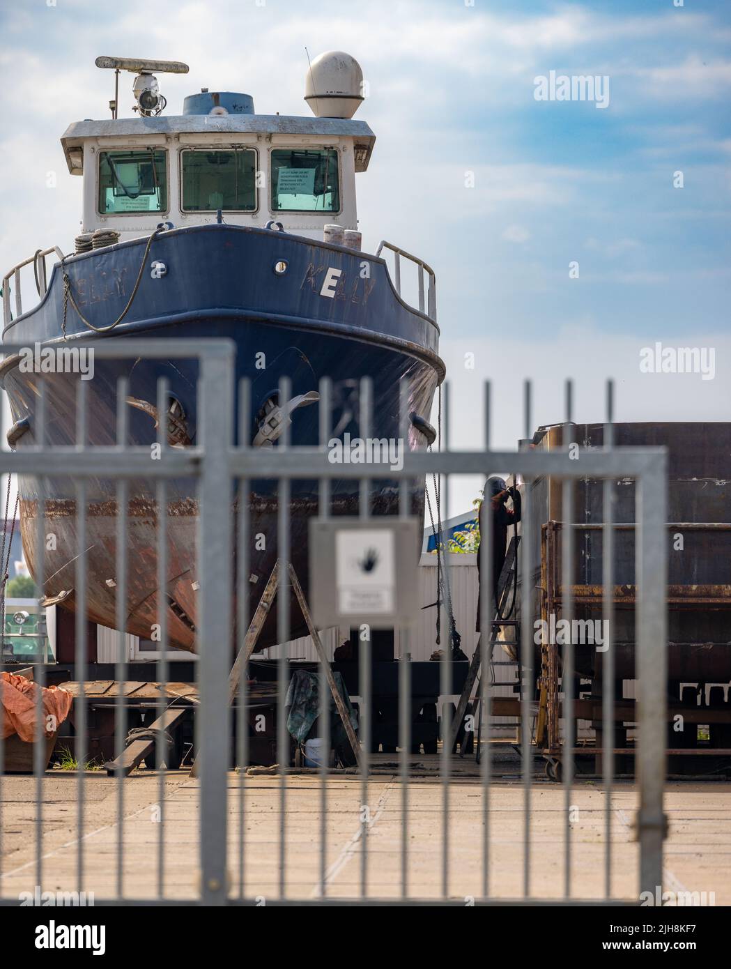 A fishing boat with a grey steel fence Stock Photo - Alamy