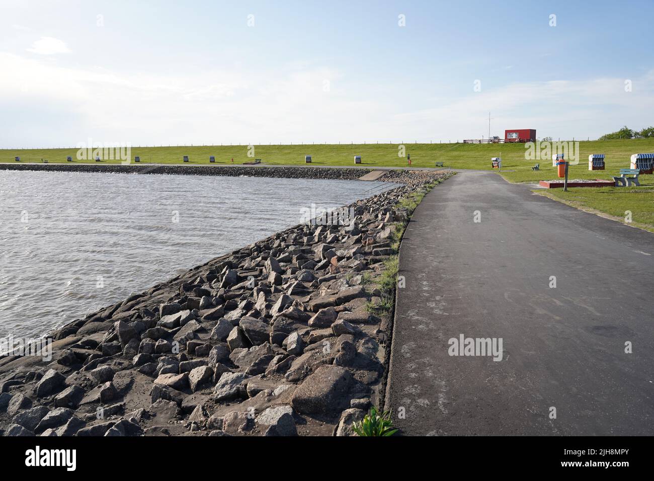 The stone seawall structure along the road Stock Photo - Alamy
