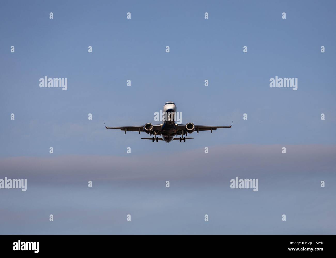 A view of a beautiful airplane flying high in the sky over Boston ...
