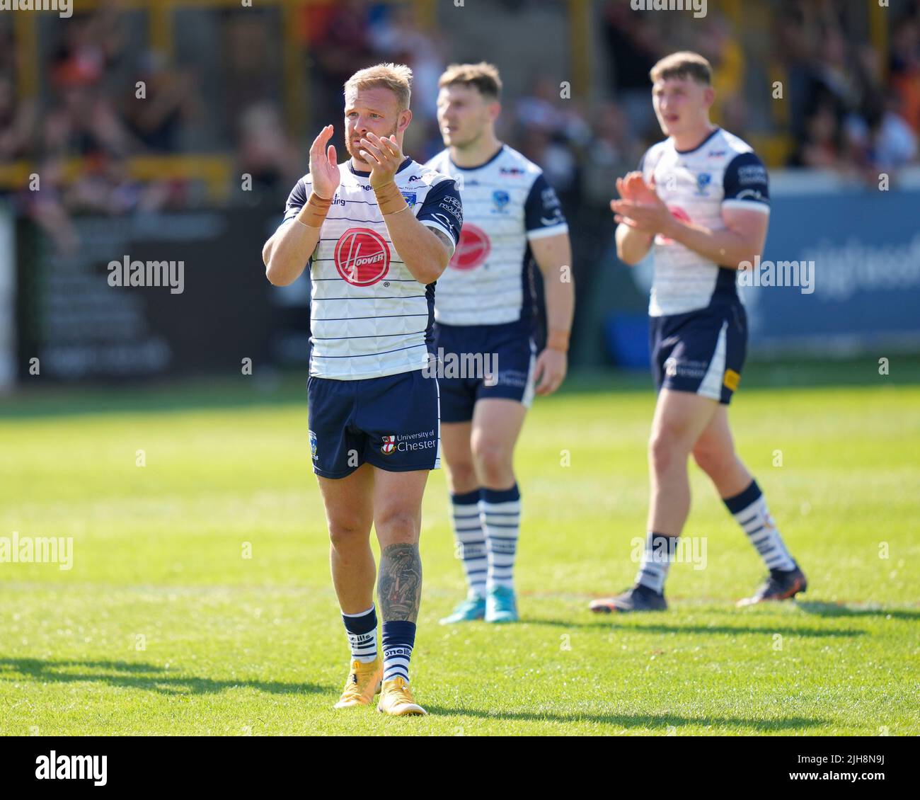 Oliver Holmes #12 of Warrington Wolves salutes the fans after the game ...