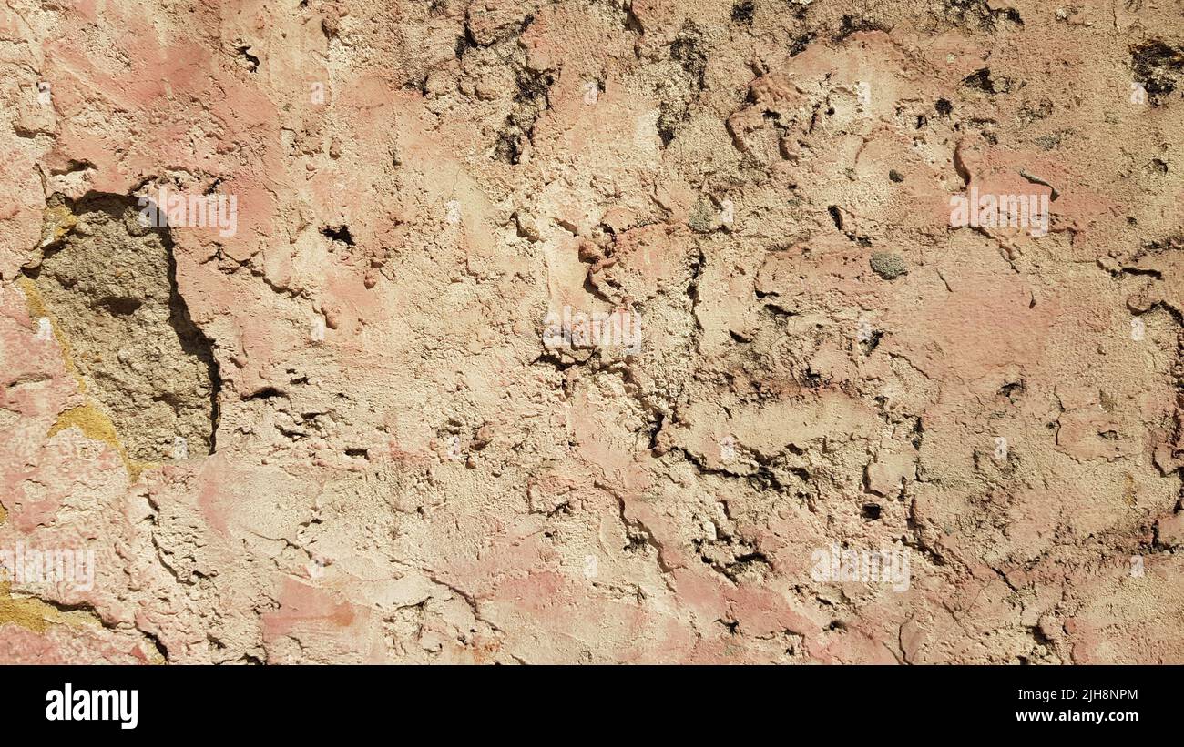 A worn plaster wall texture with a red and yellow tinge Stock Photo - Alamy