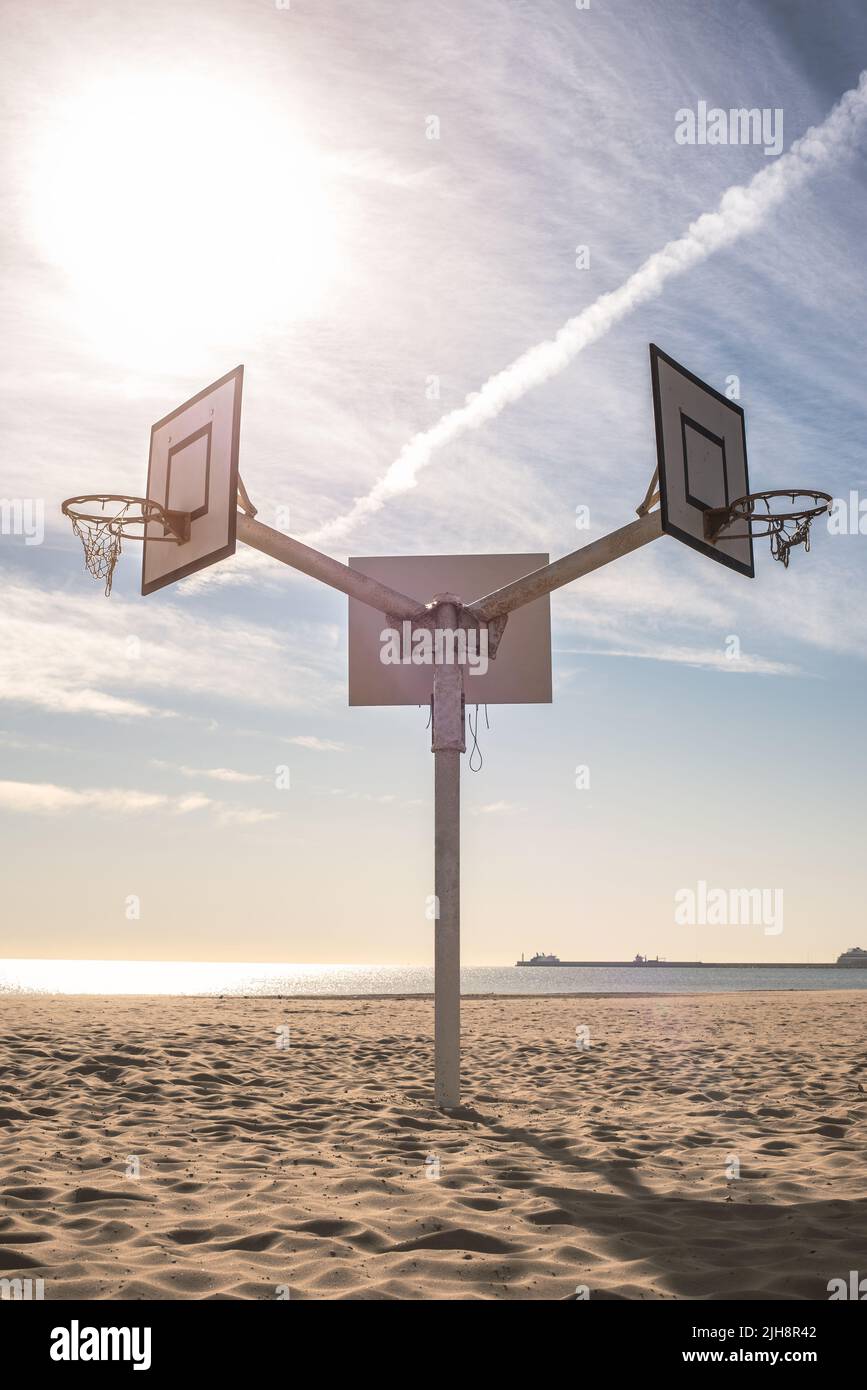 The vertical view of the double-sided basketball hoop on the beach ...