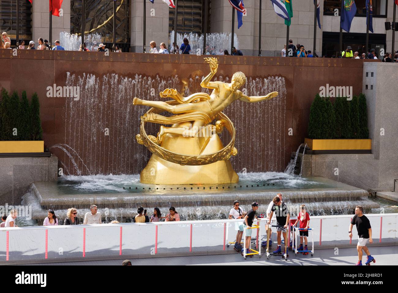 A group of tourists with roller blades near Prometheus statue at ...
