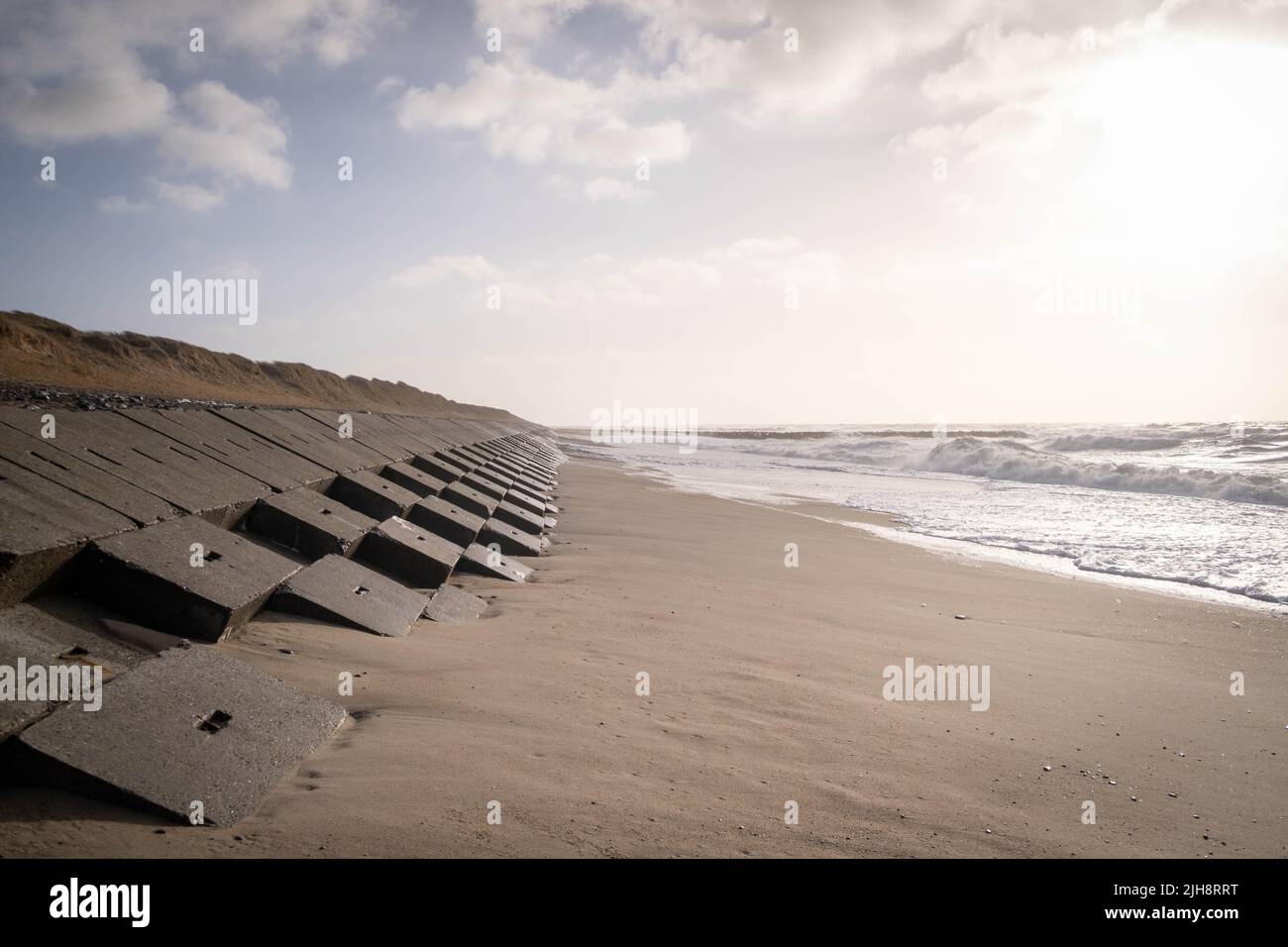 A stone seawall at a beach for erosion protection Stock Photo - Alamy