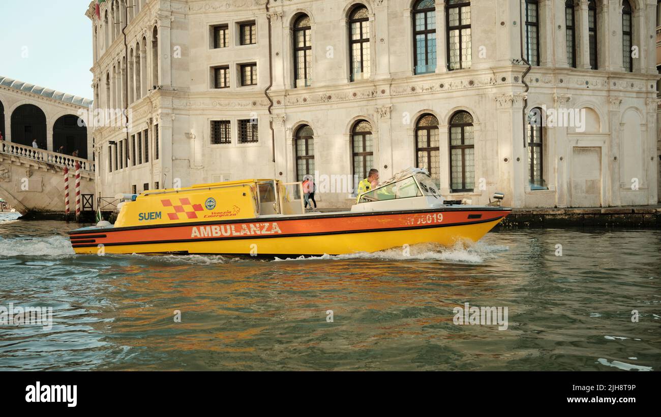 A yellow water ambulance boat sailing on the river in Venice, Italy ...