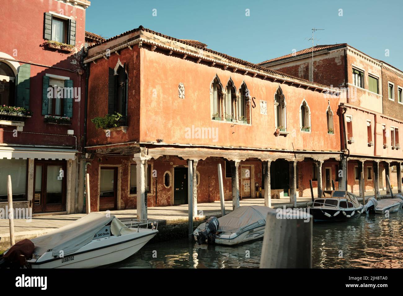 A scenic view of a canal and residential buildings on the island of ...