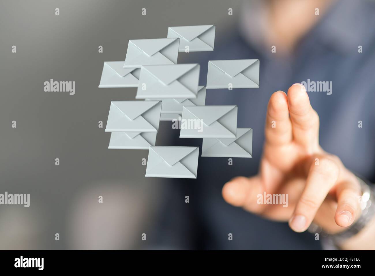 A businessman on a blurry background touching a floating render of ...