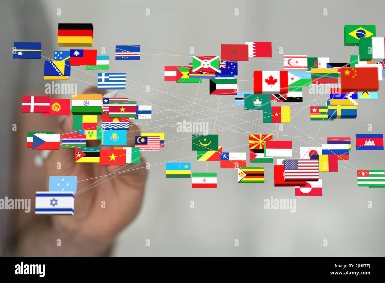 A man touching a floating render of flag icons Stock Photo - Alamy