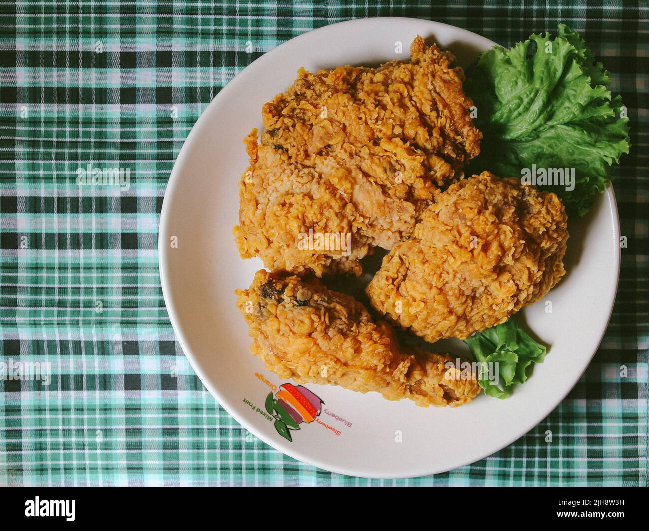 A top view of crispy fried chicken on checkered background Stock Photo ...