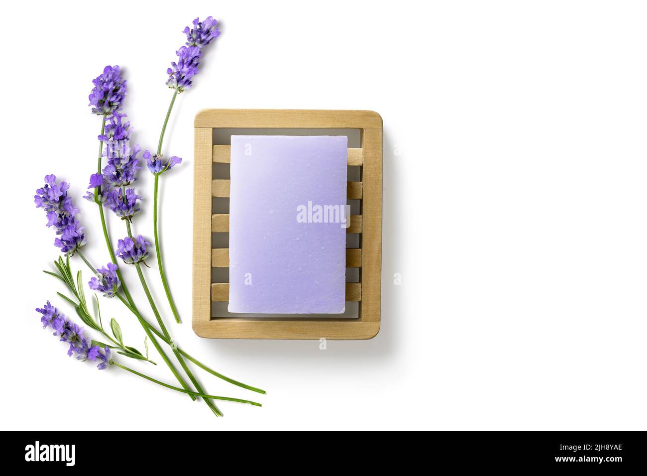 Homemade lavender soap on wooden soap dish isolated on white background ...
