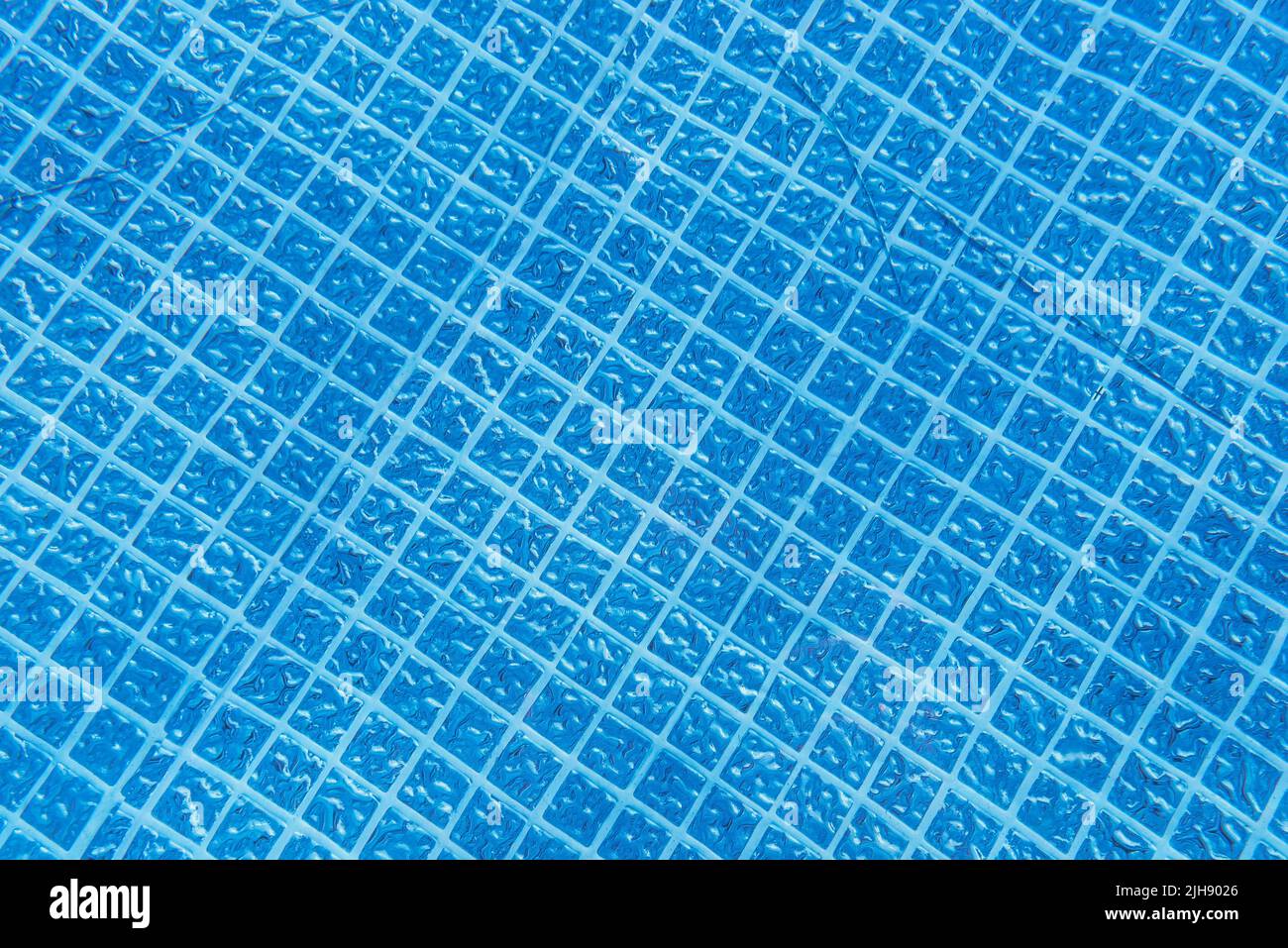 Background made from the bottom of a garden pool, visible rubber bottom ...