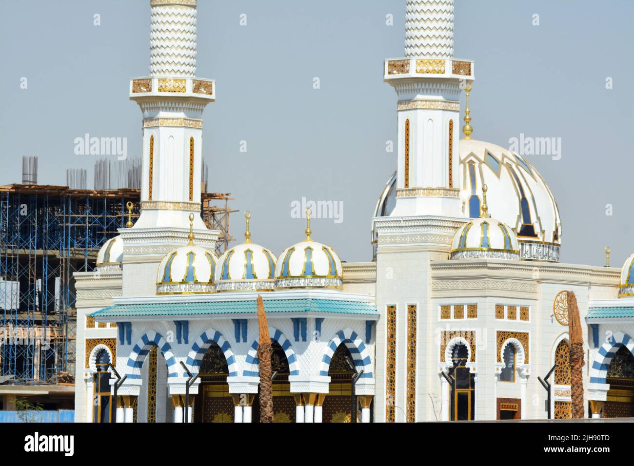 A beautiful white and blue mosque with multiple domes and minarets ...
