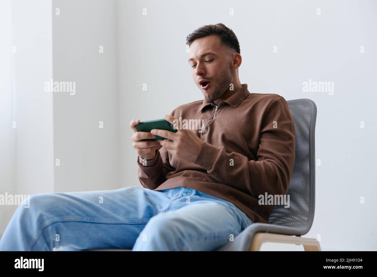 Mobile App concept. Cool RPG game offer. Overjoyed attractive smiling ...