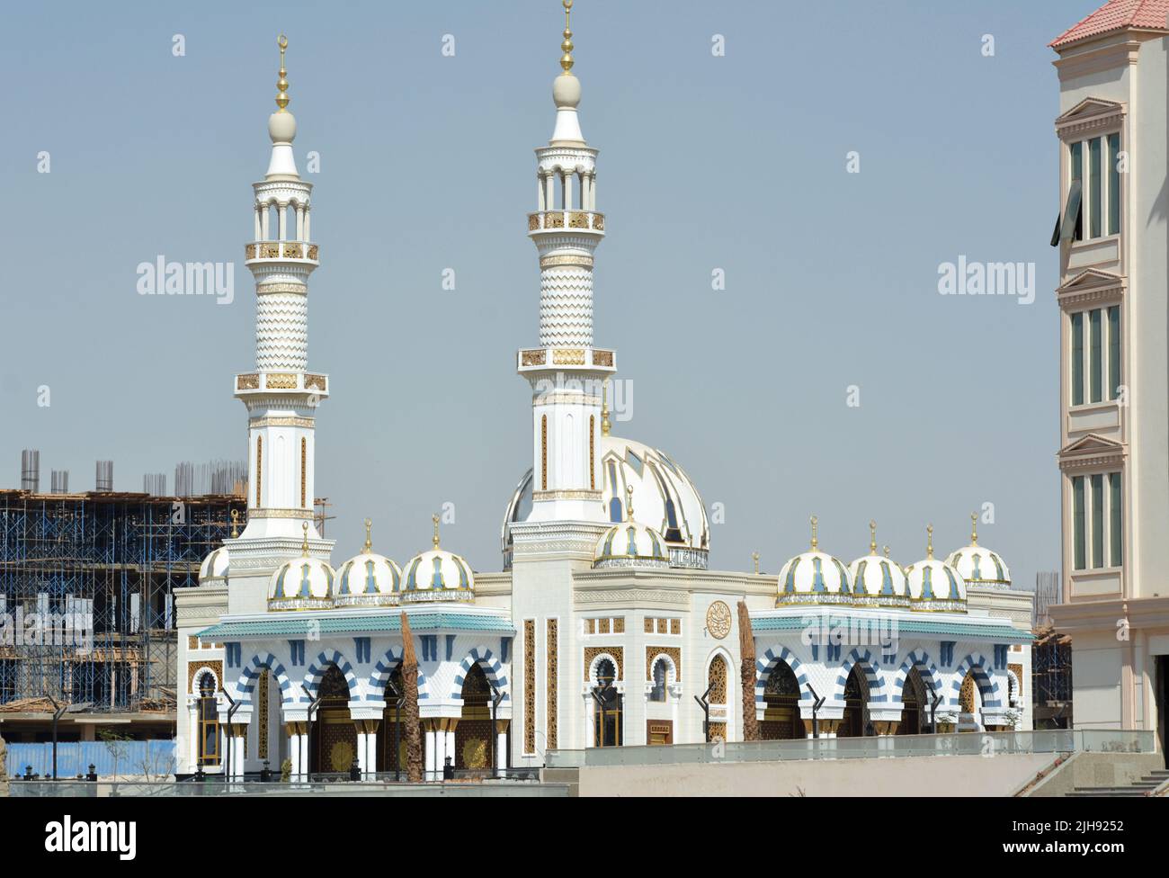 A beautiful white and blue mosque with multiple domes and minarets ...