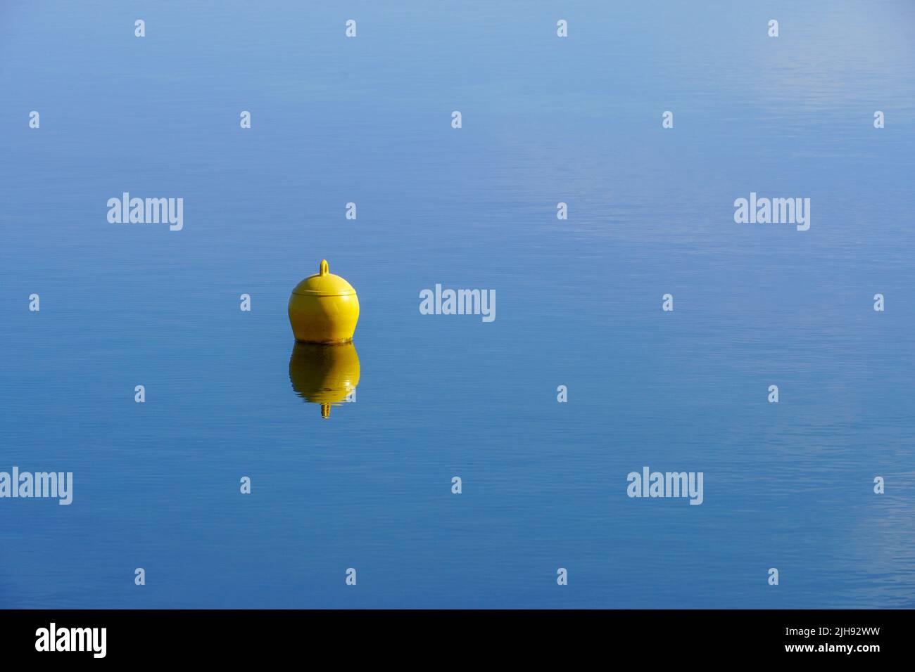 Yellow buoy on the blue calm surface of the sea Stock Photo - Alamy