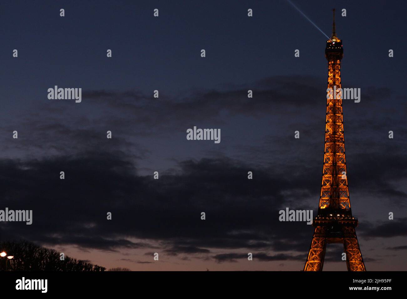 The Eiffel Tower lit up during sunset in Paris, France Stock Photo - Alamy