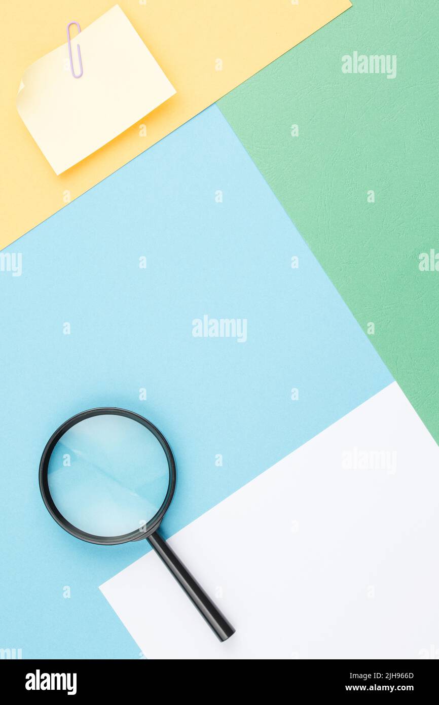 Colored background with magnifying glass Stock Photo - Alamy