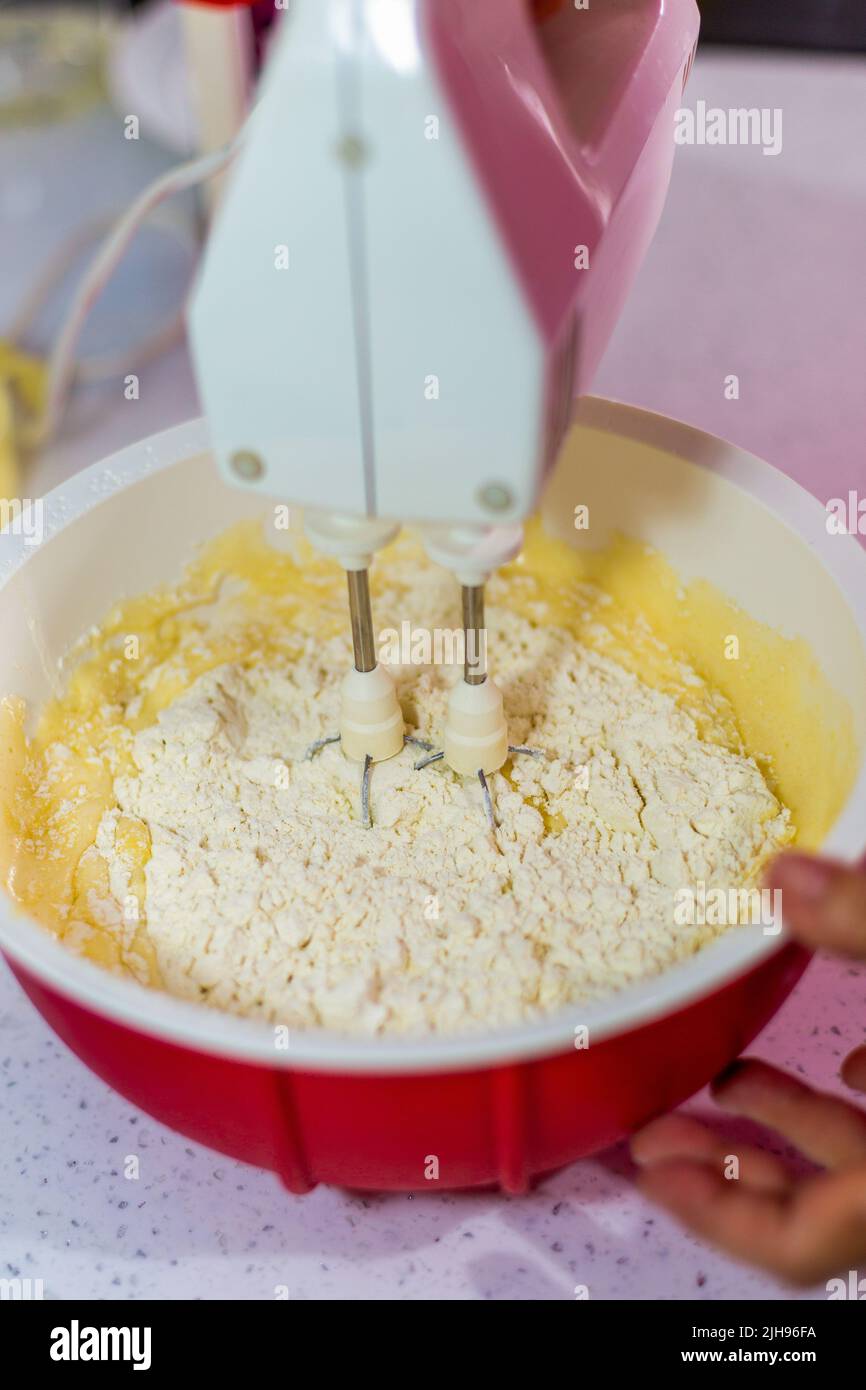 Mix flour and eggs to make cake Stock Photo - Alamy