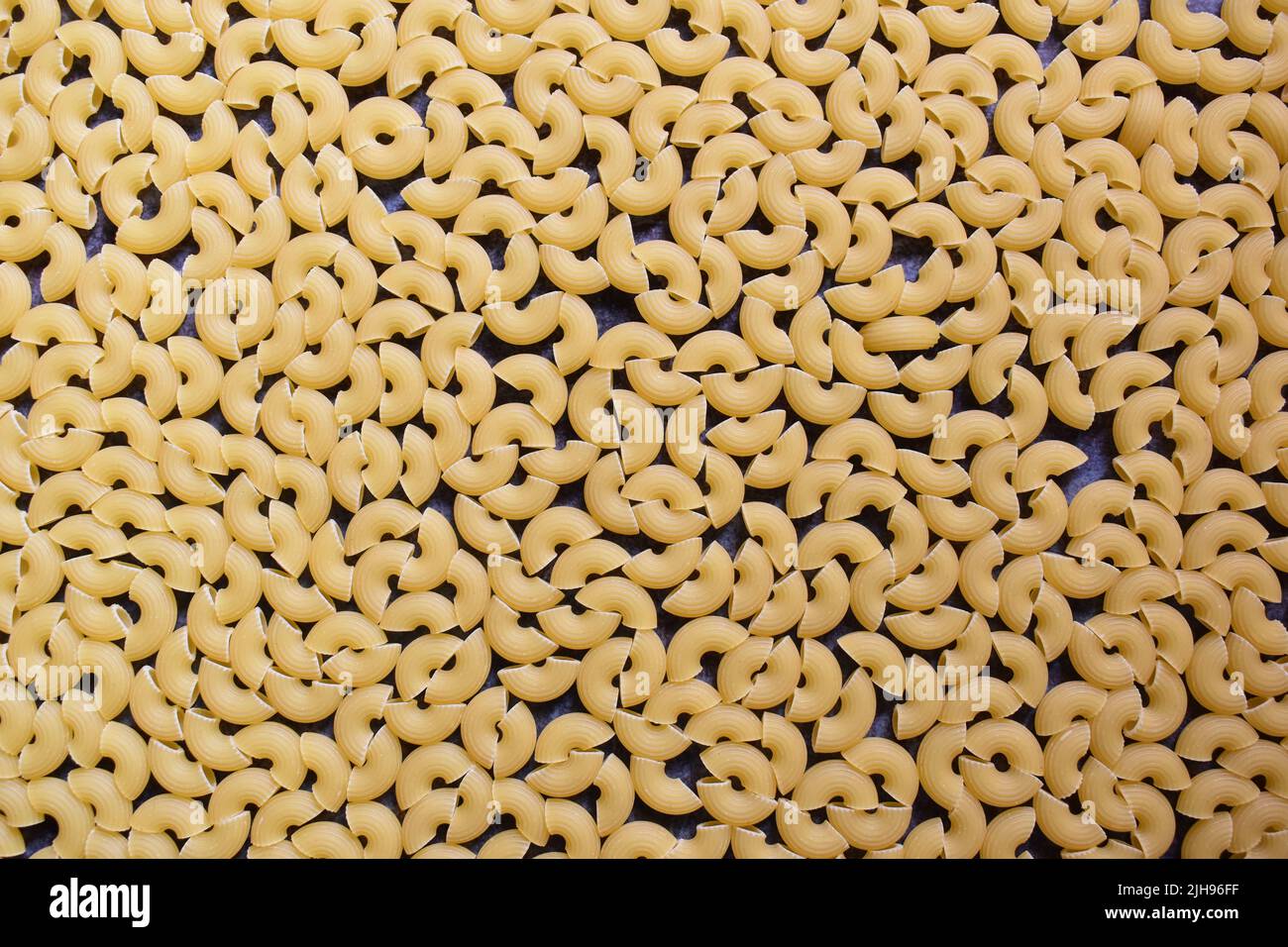 Raw whole dried ridged elbow macaroni pasta Stock Photo - Alamy