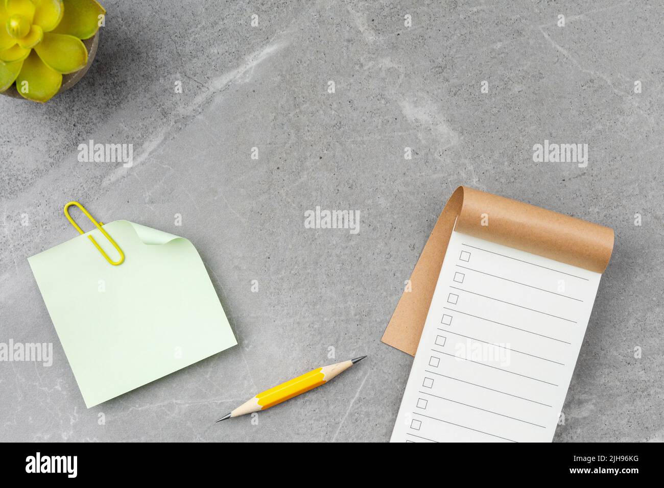 Open notebook on gray marble background Stock Photo - Alamy
