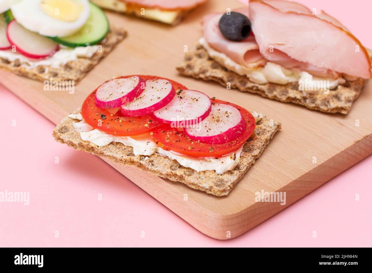 Different Whole Grain Crispbread with Ham, Tomato, Radish, Cucumber and ...