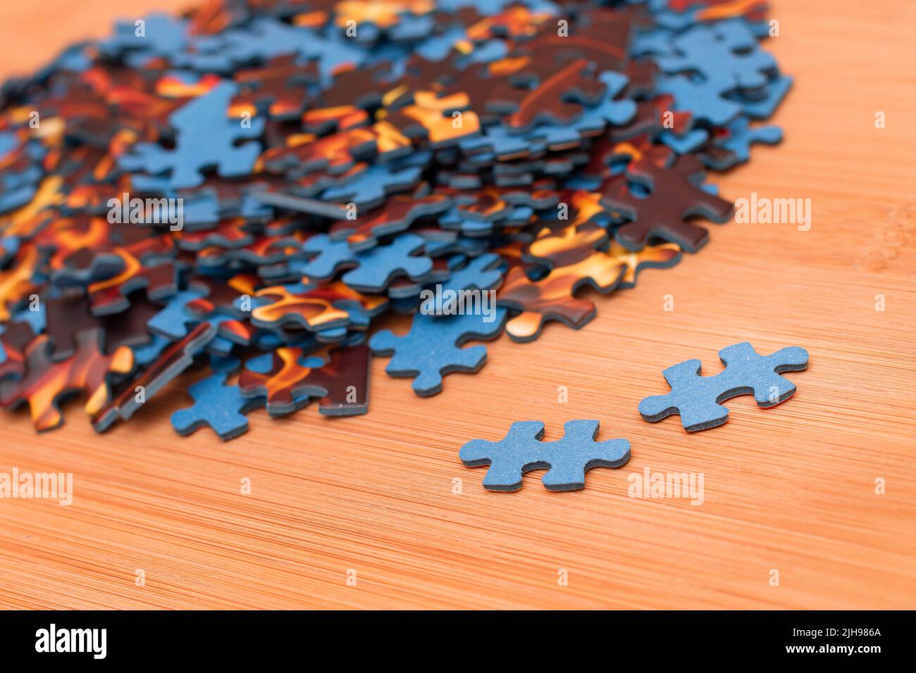 Colorful Peaces of a Mixed Jigsaw Puzzle Lie on the Wooden Table ...