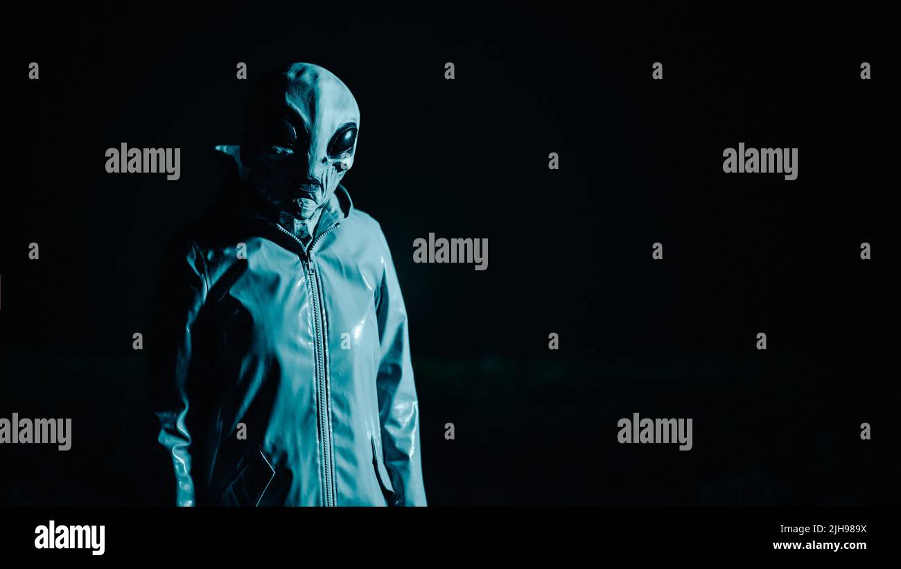 Portrait of spooky alien in dark black background. Scary mask, vinyl ...