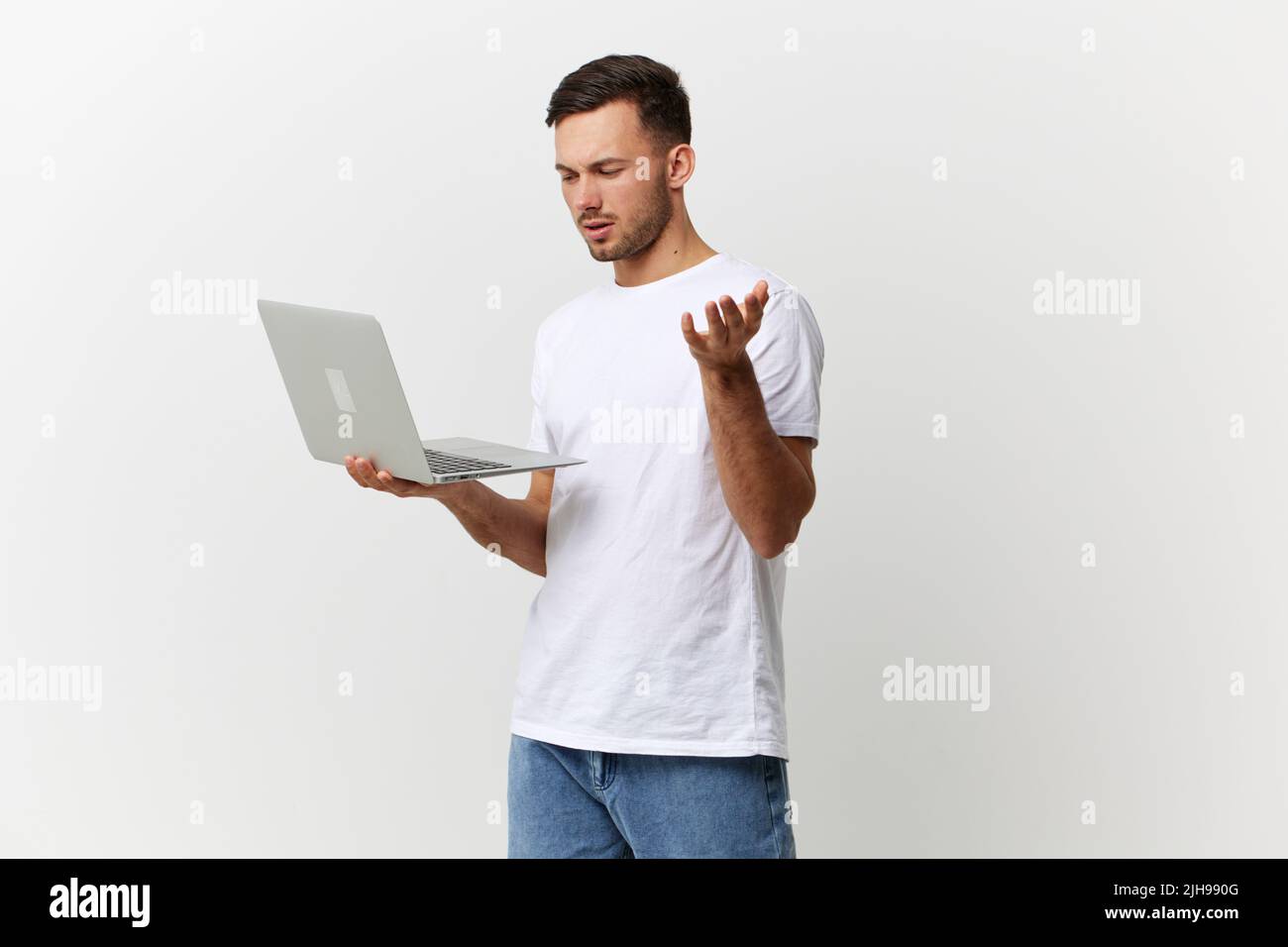 Confused unhappy tanned handsome man in basic t-shirt irritated by bad ...