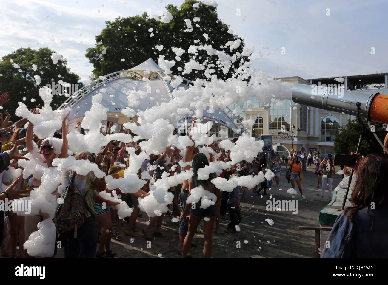 People covered in foam seen dancing during the event. As a holiday ...