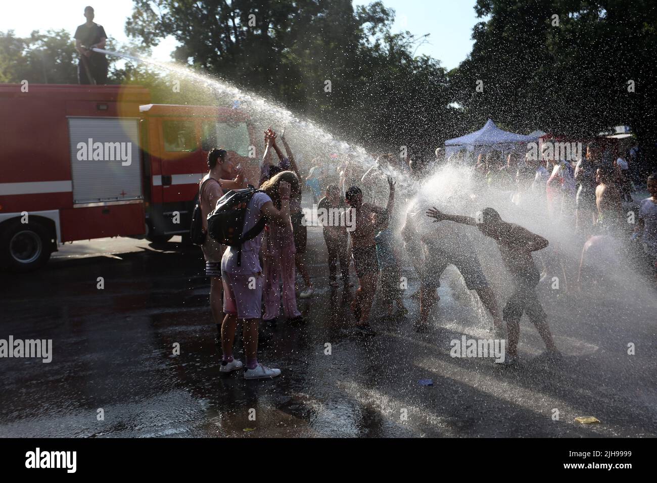 Truck sprays water on man hi-res stock photography and images - Alamy