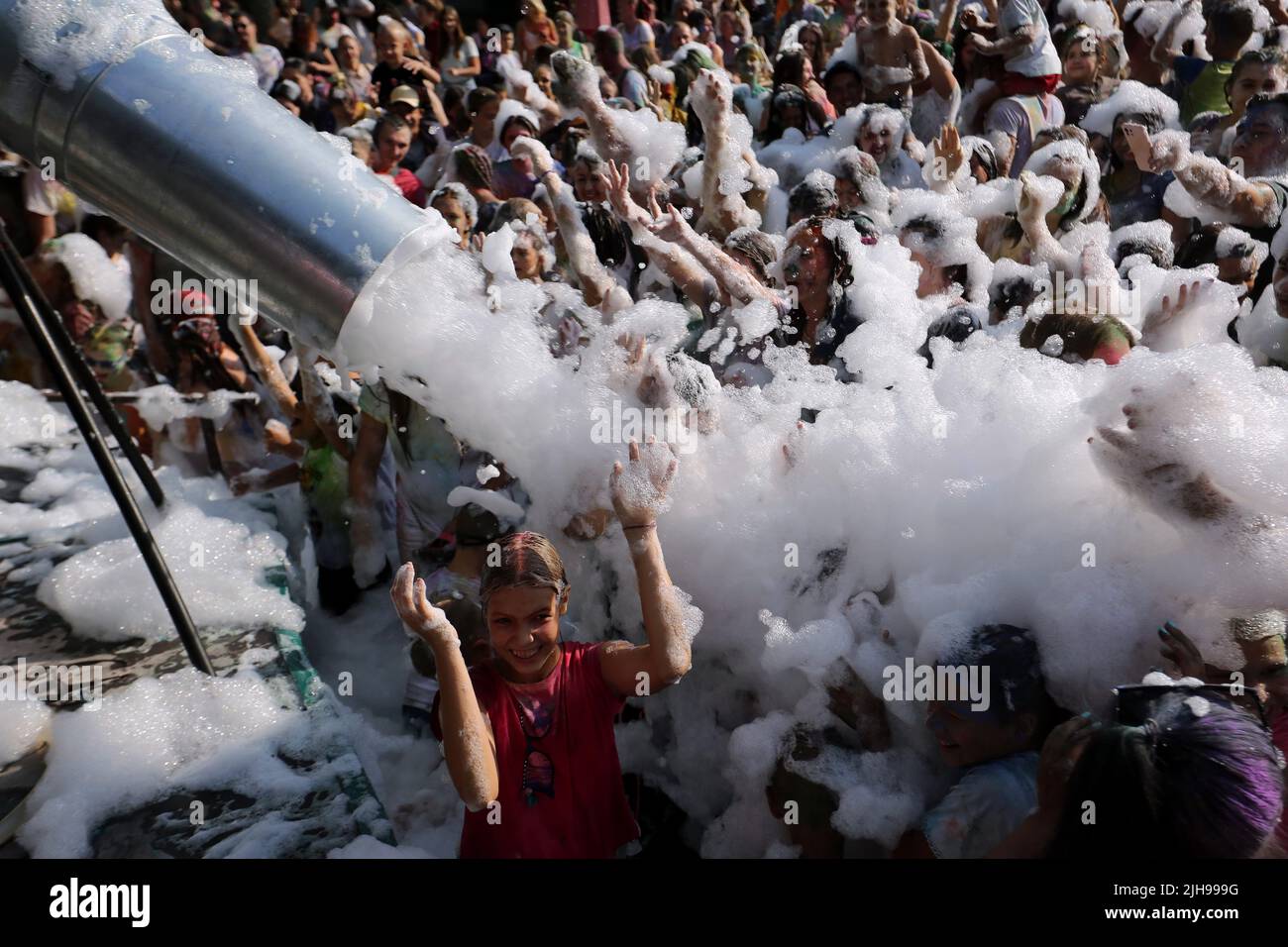 People covered in foam seen dancing during the event. As a holiday ...