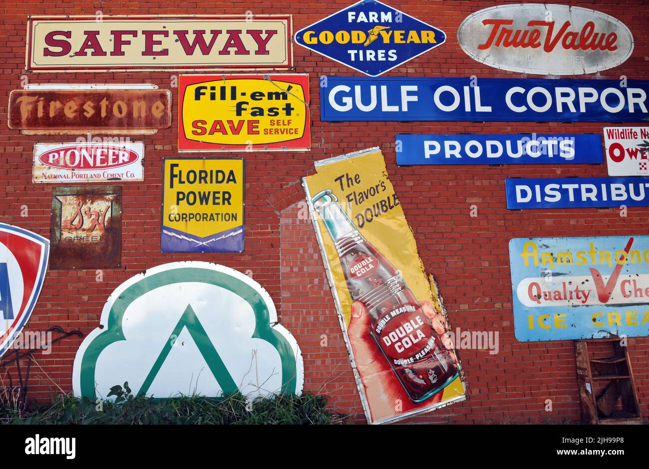 Vintage advertising signs decorate the outside brick wall of the ...