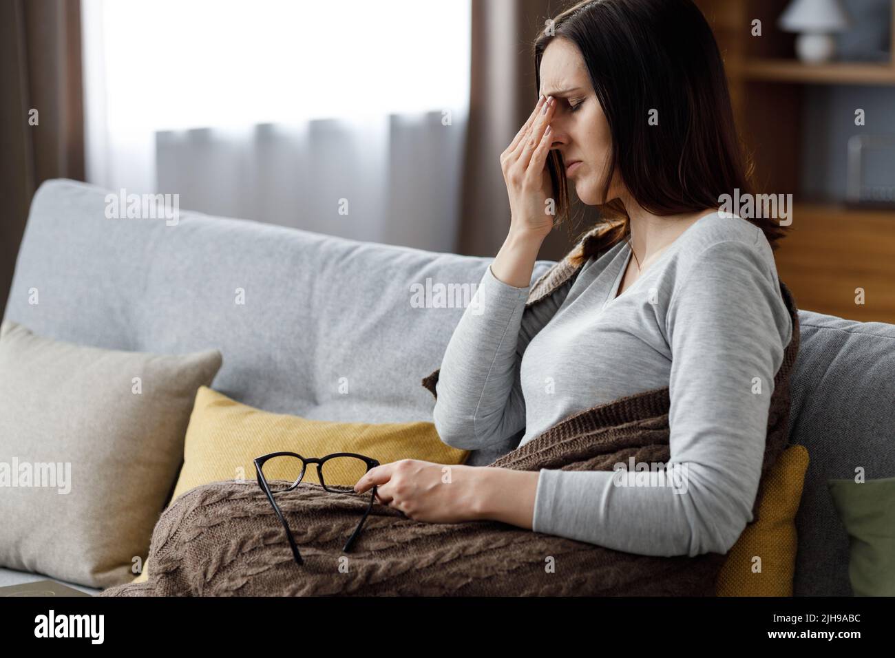 Young woman woman taking off eyeglasses feeling eye strain.Tired woman ...