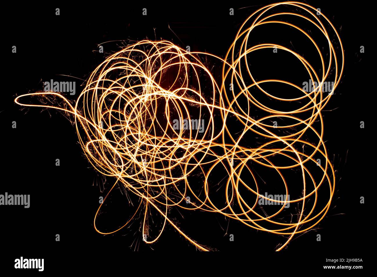 A long exposure shot of chaotic yellow light against the black ...