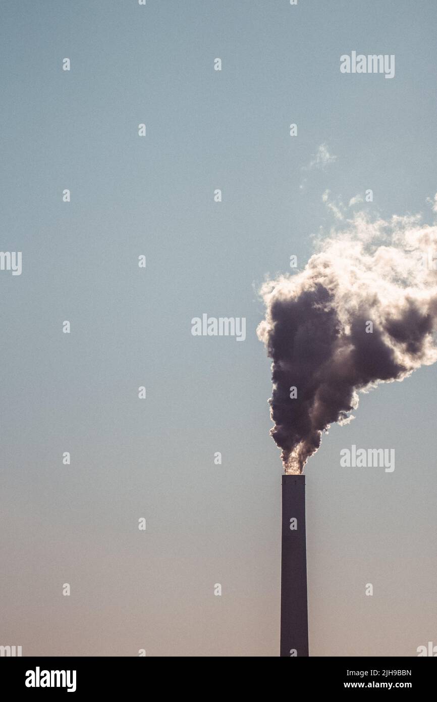 A vertical shot of smoke coming out of an industrial tube Stock Photo ...