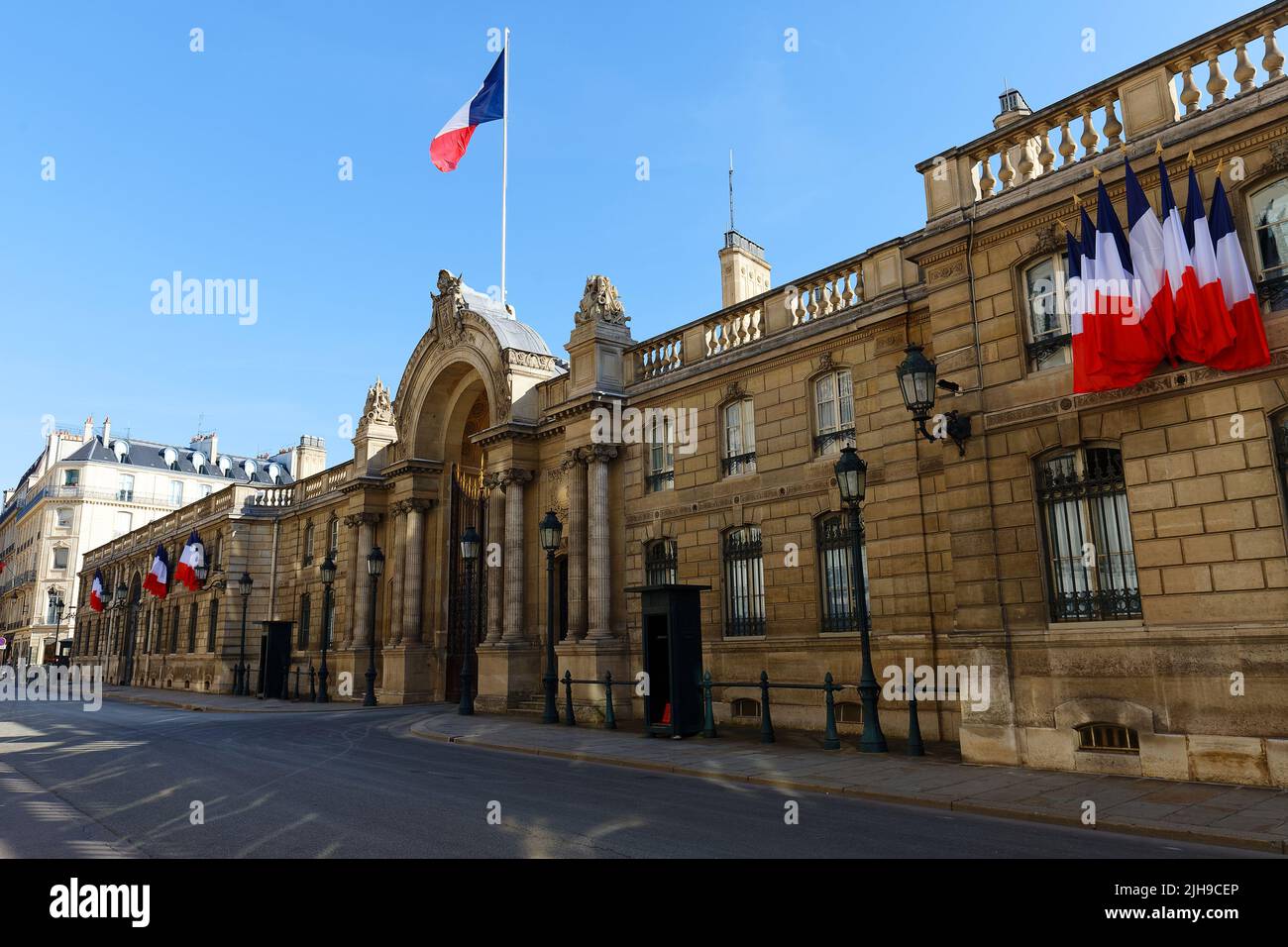 View of entrance gate of the Elysee Palace decorated with national ...