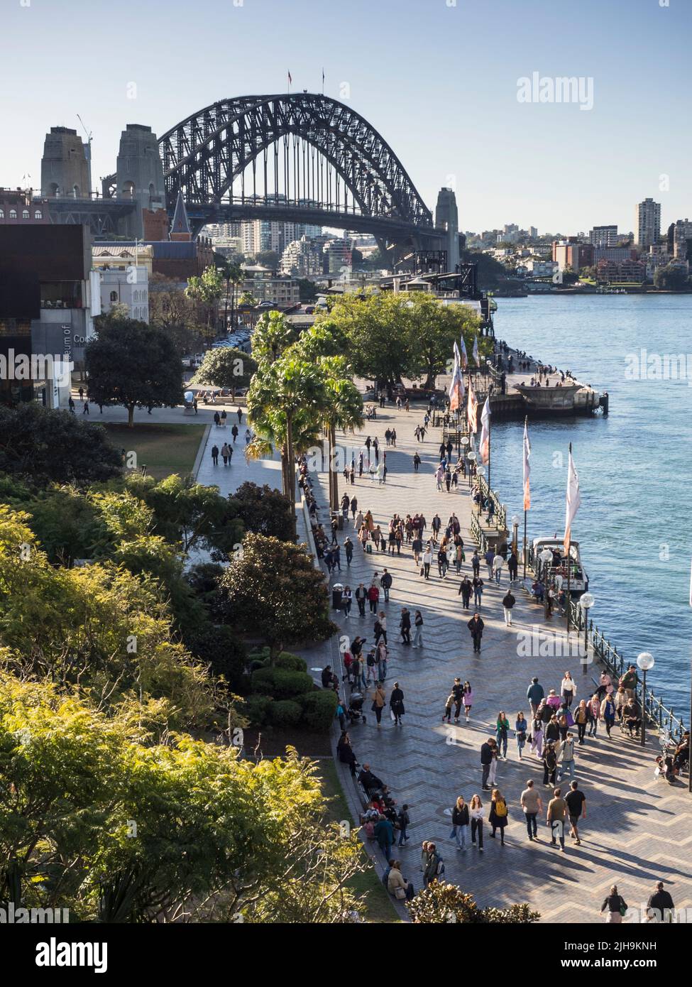 Tourists promenade along the western side of Circular Quay on Sydney ...