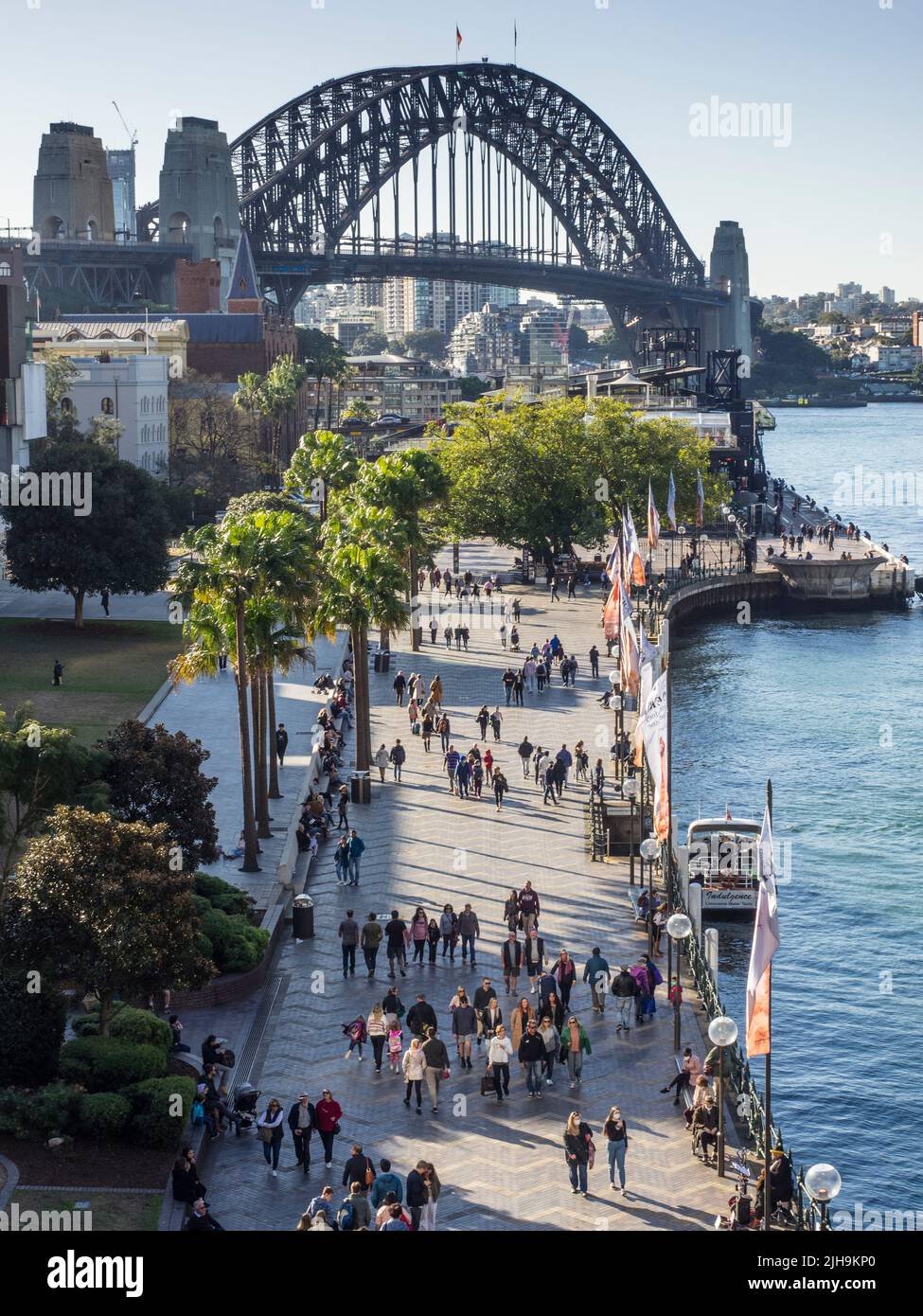Tourists promenade along the western side of Circular Quay on Sydney ...