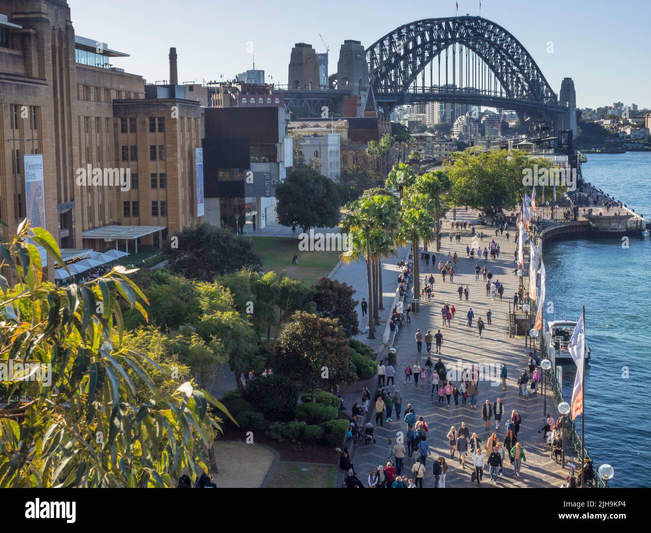 Tourists promenade along the western side of Circular Quay with the ...