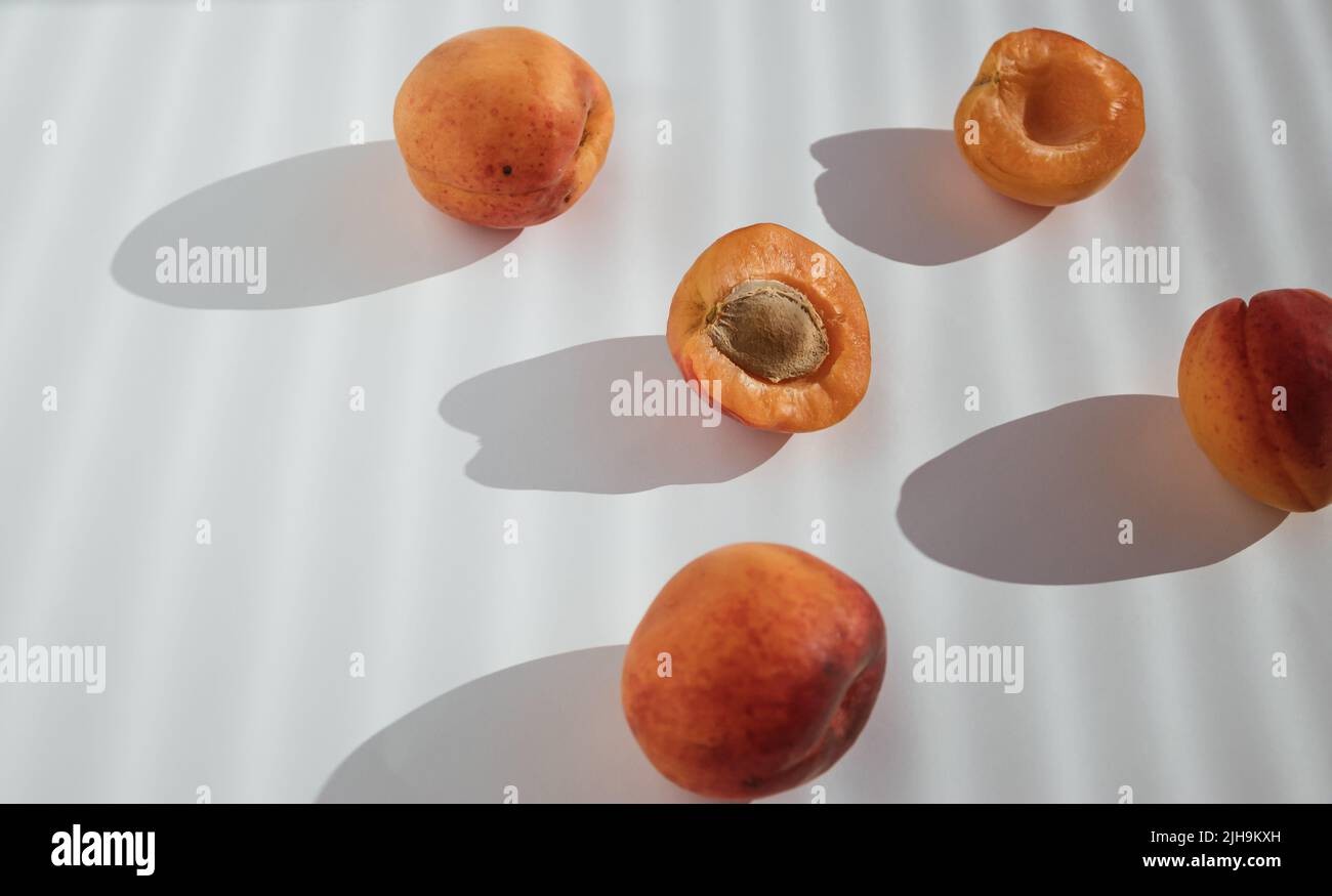 Summer vintage scene with fresh apricots and shadows on bright ...