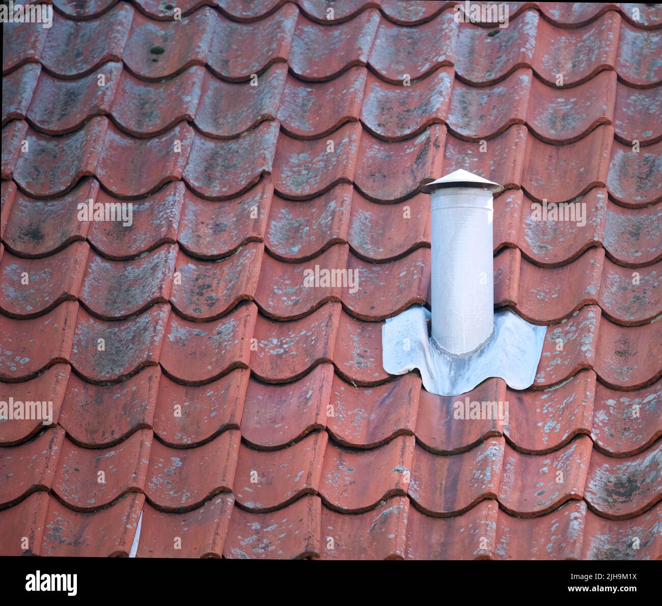 Closeup of red brick chimney chute against blue sky with clouds for ...