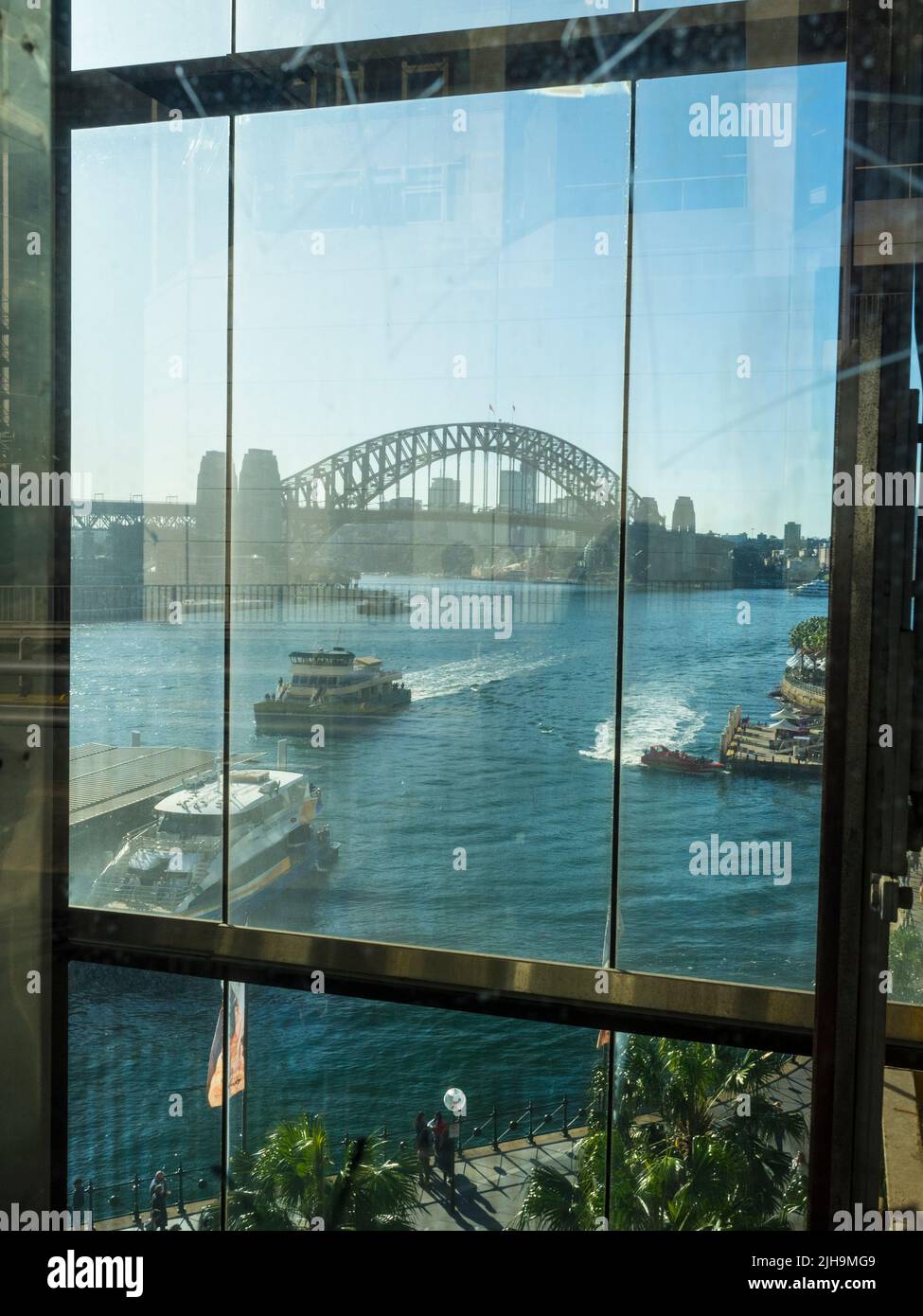 The Sydney Harbour Bridge and Circular Quay framed through a glass ...