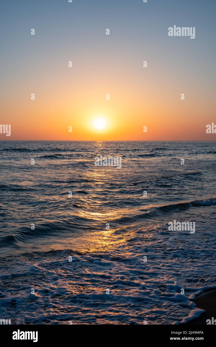 vertical photo of a sunset on the sea Stock Photo - Alamy