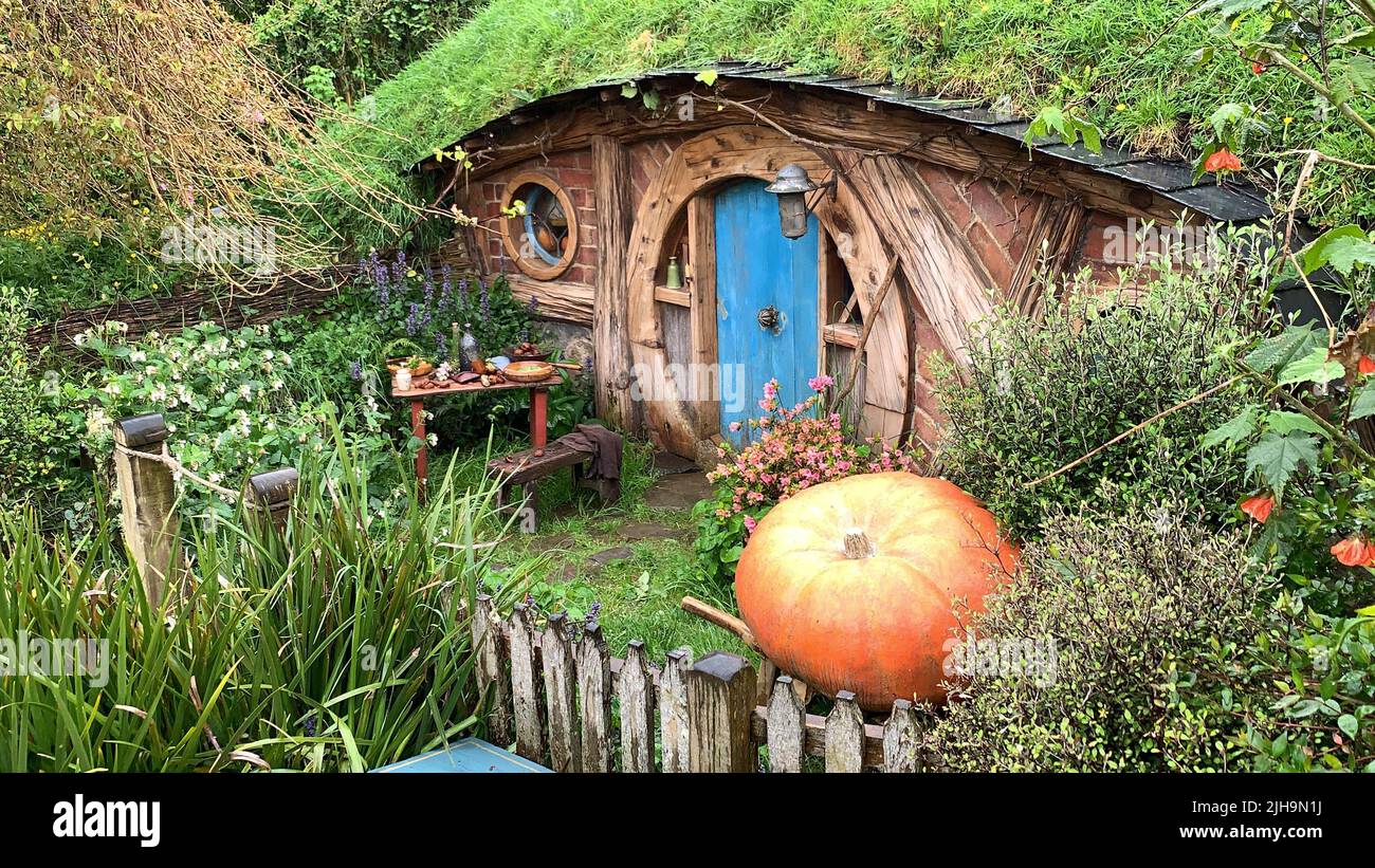 A close-up shot of the Hobbiton Movie Set home with a blue door Stock ...